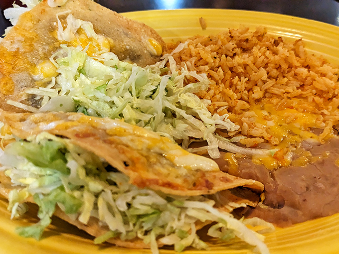 This isn't just food; it's edible art. The legendary rice and beans share the spotlight with perfectly crafted tacos and enchiladas on a plate that sings with flavor.