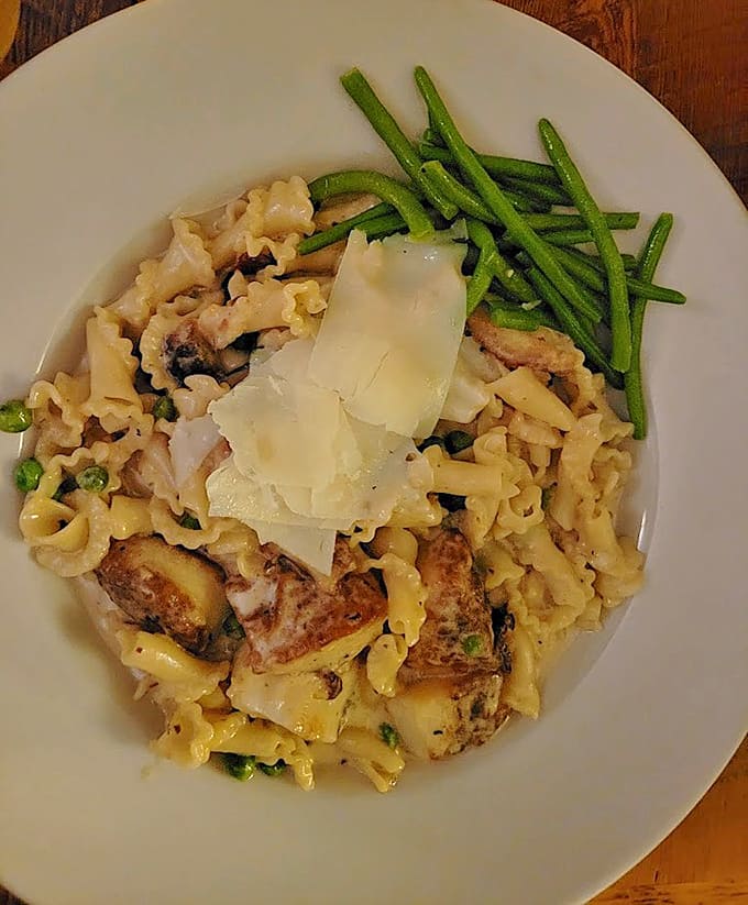 Scallop Carbonara that's launched a thousand return visits, with campanelle pasta catching every drop of that dreamy cream sauce.