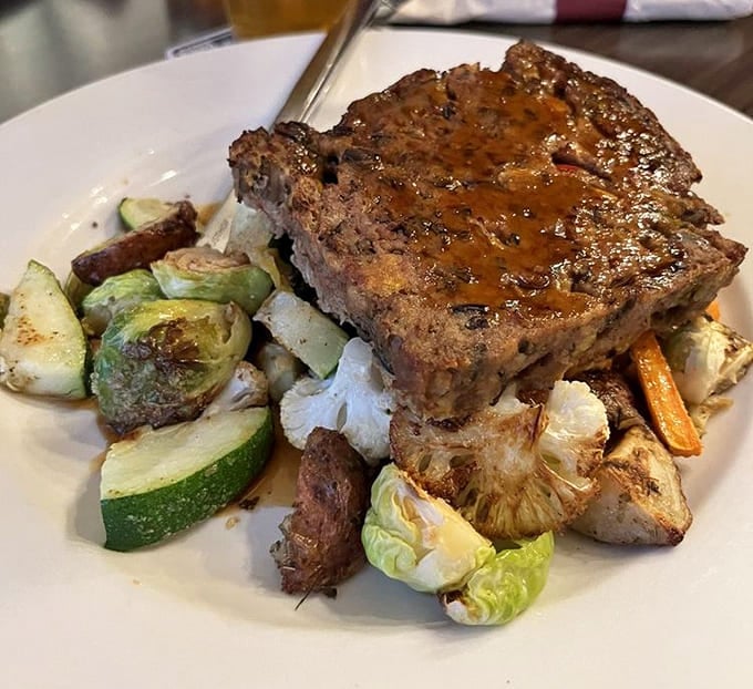 The legendary bison meatloaf with wild rice, glazed to perfection and surrounded by roasted vegetables that know their supporting role.