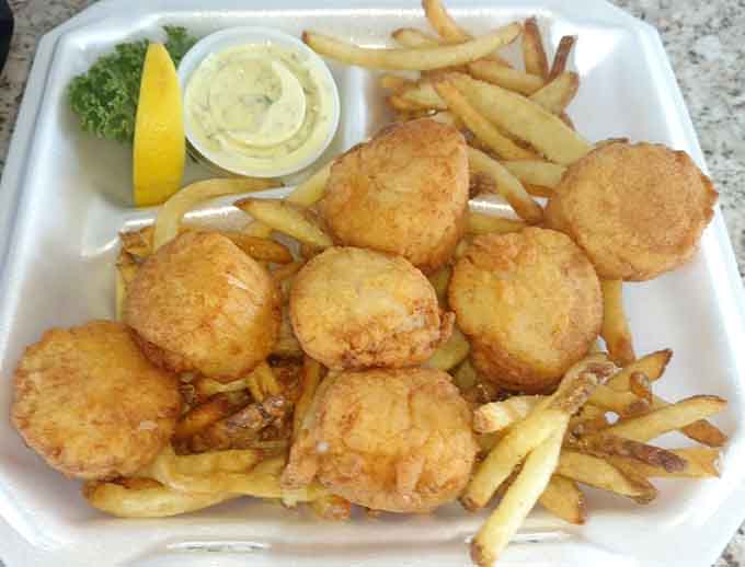 These golden fried scallops achieve that perfect balance of crispy exterior and tender interior, served with fries that'll have you reaching for more even when you're full.