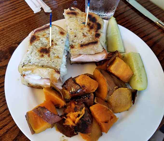 The Turkey Reuben arrives beautifully grilled with melted cheese oozing out, accompanied by perfectly roasted vegetables that add color and nutrition to the plate.