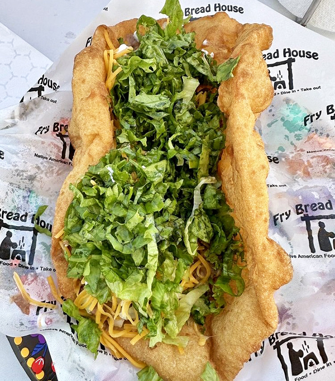 The Ultimate Taco arrives like an edible work of art &ndash; crispy fry bread cradling a mountain of fresh lettuce, cheese, and fillings.