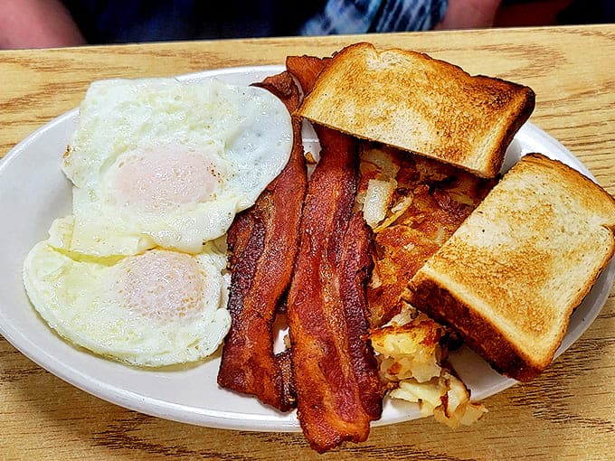 Morning perfection on a plate &ndash; golden eggs, crispy bacon, and home fries that make hitting the snooze button seem like a crime against breakfast.