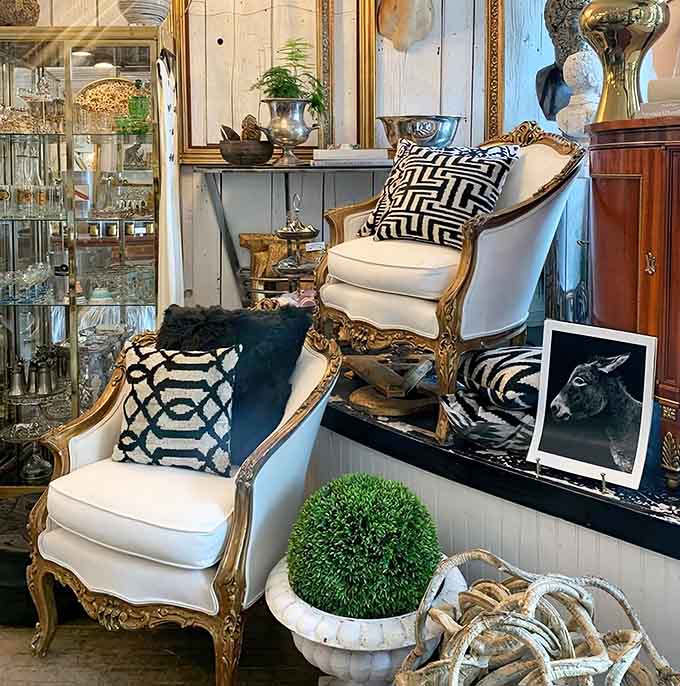 French-style armchairs in pristine white upholstery make you wonder why anyone settles for furniture that doesn't look like it belongs in a ch&acirc;teau.
