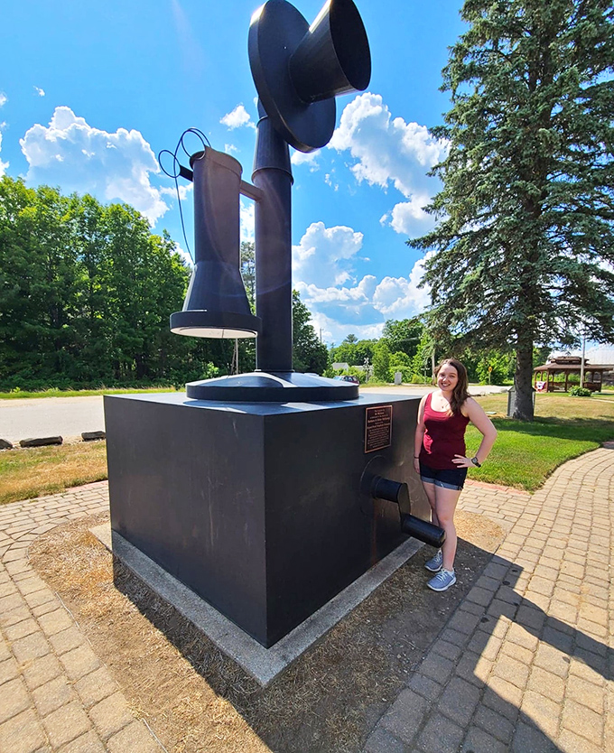 A visitor provides perfect scale next to this mammoth monument, demonstrating just how far we've come from these hand-cranked communication dinosaurs.
