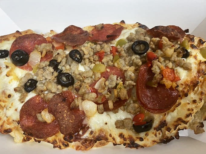 Behold the supreme pizza waffle in all its glory, loaded with pepperoni, sausage, and olives nestled in crispy waffle pockets of joy.