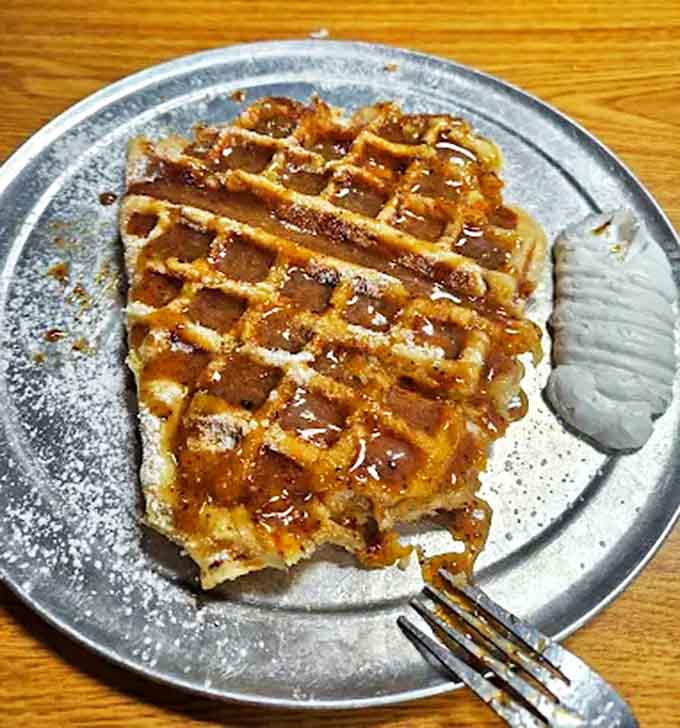 Waffle: Golden-brown perfection with those signature deep pockets collecting sweet caramel sauce &ndash; architecture you can eat and absolutely should.
