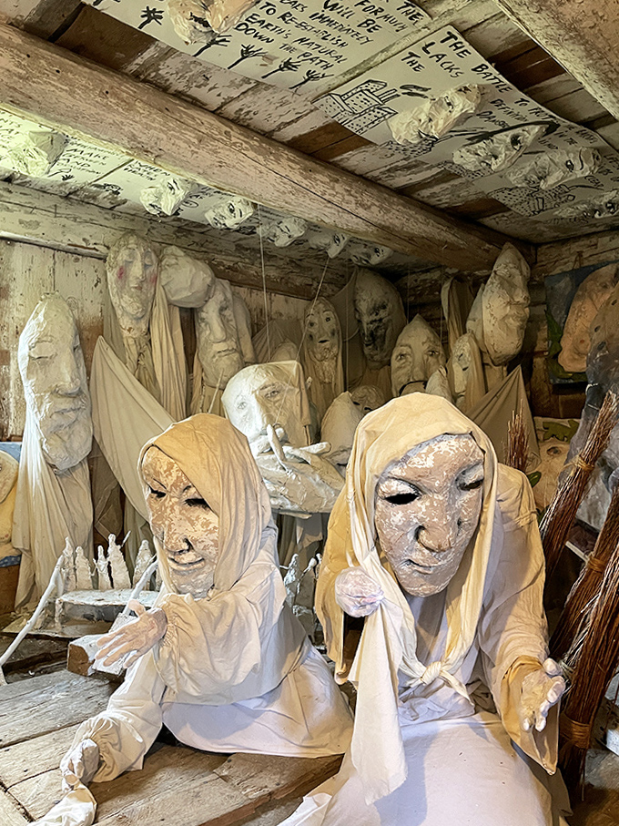 Ghostly figures in pale shrouds seem to emerge from the walls themselves, their haunting presence a meditation on mortality and memory.