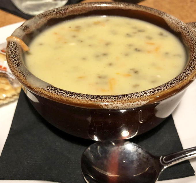 This isn't just soup &ndash; it's a creamy hug in a speckled ceramic bowl, wild rice swimming in a broth that could make a grown person weep with joy.