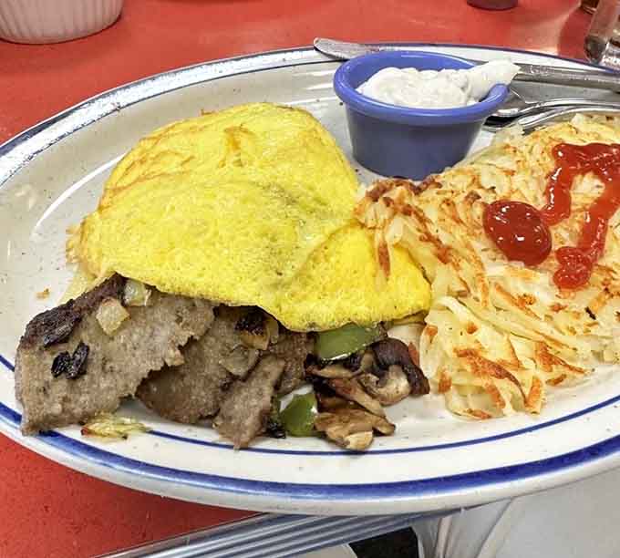 The Gyro Omelet proves that Mediterranean meets Midwest isn't just possible, it's absolutely delicious, with fluffy eggs embracing seasoned meat and melted cheese.