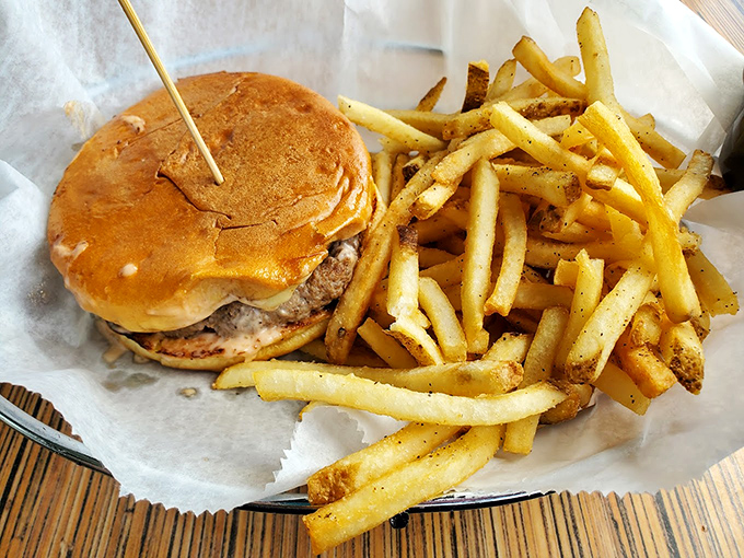 Burger bliss between buns &ndash; this hand-formed patty with melty cheese and golden fries might make you temporarily forget your table manners.