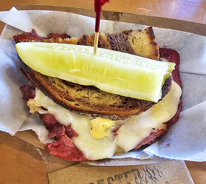 This isn't your average Reuben &ndash; layers of tender corned beef, melty Swiss, and tangy sauerkraut get elevated by the mysterious "Kickin' Pickle Sauce" that locals line up for.