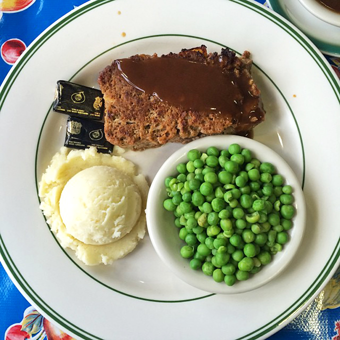 Meatloaf perfection on a plate &ndash; tender, flavorful, and swimming in that rich brown gravy that haunts your dreams afterward.