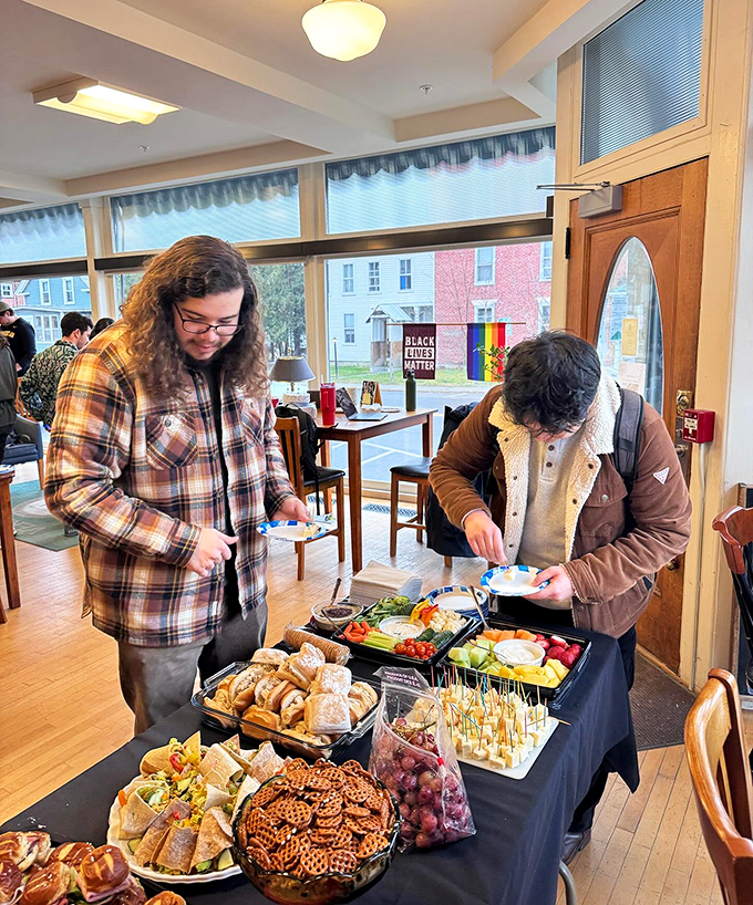 The community table transforms into a feast for both mind and body, where strangers become friends over shared plates and literary discussions.