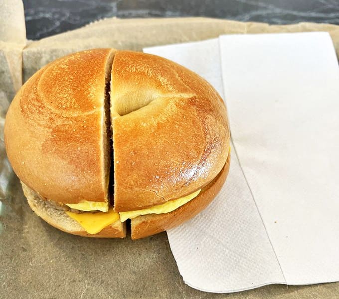 This egg and cheese bagel sandwich isn't trying to be fancy – it's comfort food perfection with melty cheese hugging a golden yolk.