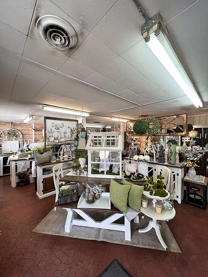 A bright, airy display of farmhouse-inspired pieces creates an inviting scene &ndash; white furniture and green accents bringing the outdoors in.