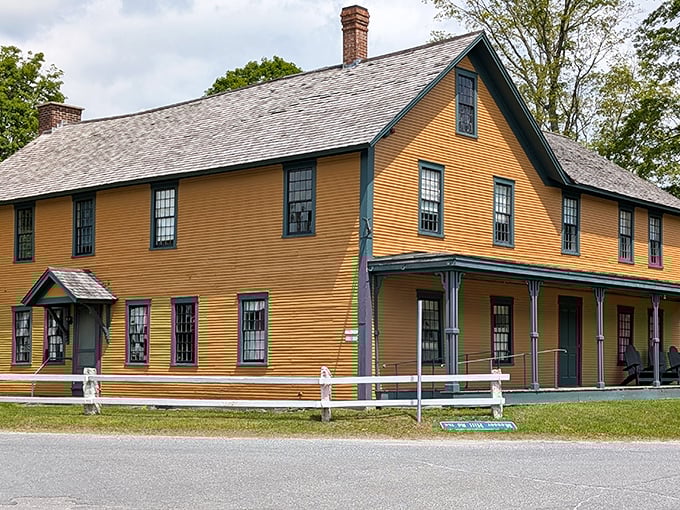 The Coolidge family homestead radiates unpretentious New England charm, its mustard-yellow clapboards glowing warmly against Vermont's rolling hills.