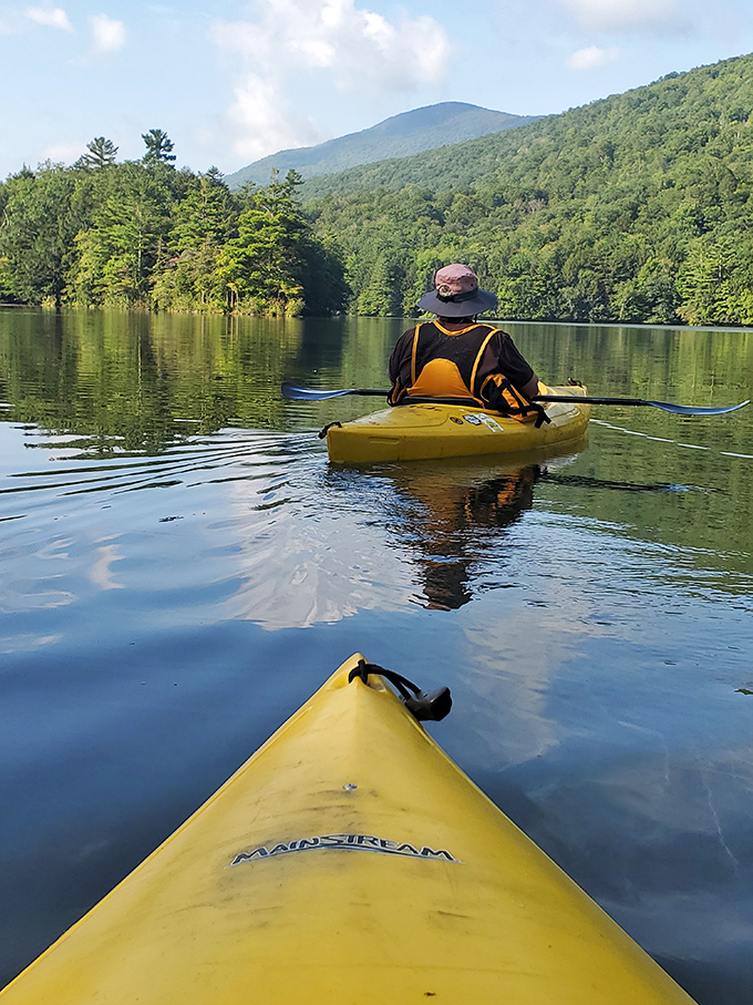Gliding across glass-like waters, kayakers discover the meditative joy of exploring Emerald Lake's hidden coves and peaceful shorelines.