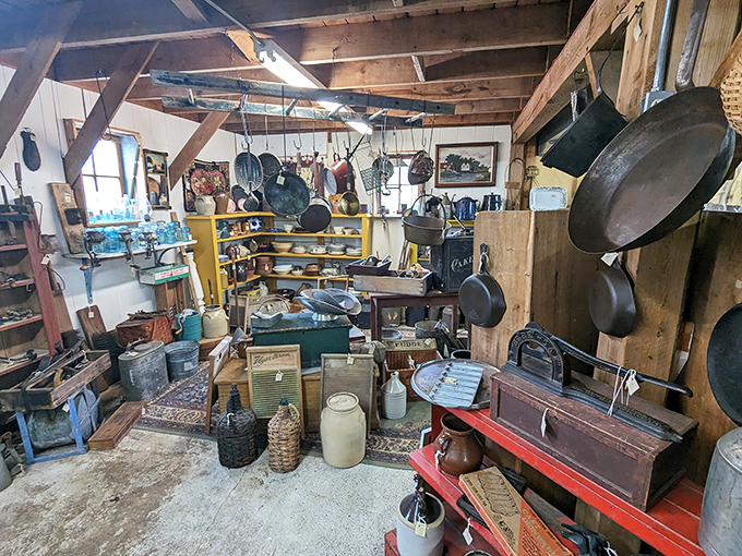 A collector's dream kitchen awaits with cast iron pans hanging from rustic beams and vintage cookware that grandmother would recognize instantly.