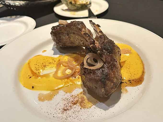 These lamb chops aren't just dinner; they're an experience &ndash; tender meat adorned with spinach, tomatoes, and feta creates a Mediterranean masterpiece.