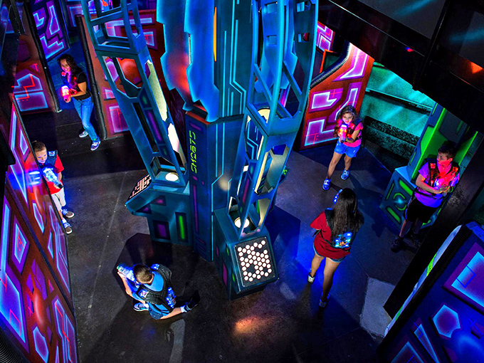 Laser tag warriors navigate the futuristic, multi-level arena where strategy meets adrenaline in a neon-bathed battleground of friendly competition.