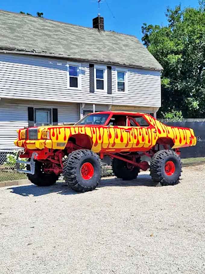 This isn't your average pickup &ndash; it's a monster truck reimagined as rolling art, its yellow body adorned with flame-like red patterns.