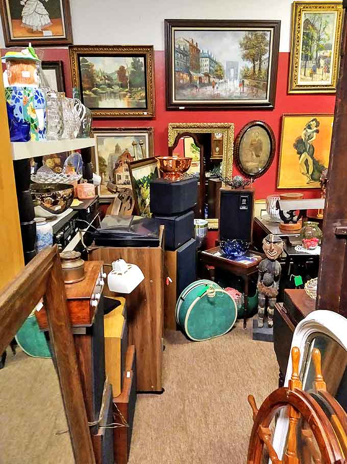 A gallery wall of vintage paintings transforms this corner into a time capsule of artistic styles, from serene landscapes to bold portraits.