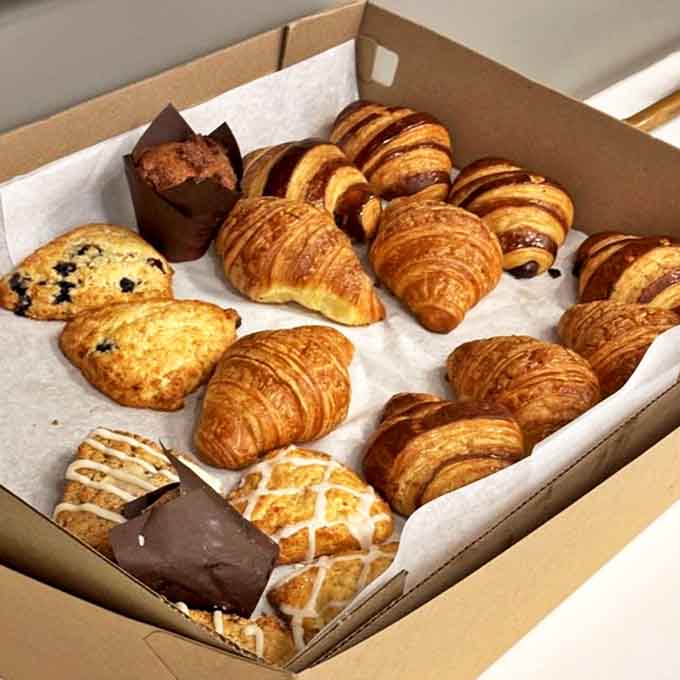 A box of buttery temptation &ndash; these aren't just pastries, they're edible works of art waiting to brighten someone's morning.