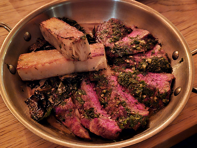 The legendary steak arrives like a carnivore's dream &ndash; perfectly seared exterior giving way to a rosy interior, accompanied by bone marrow that melts like butter.