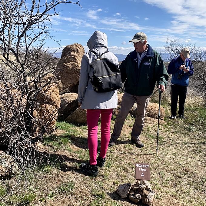Curious explorers gather around geological wonders, proving that sometimes the best classroom has no walls or ceiling.