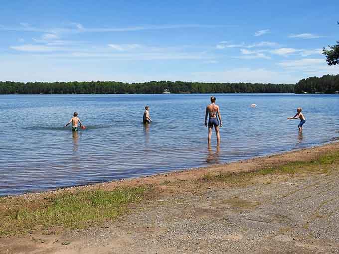 Families wade into the refreshing shallows, where water so clear it seems invisible invites summer memories.