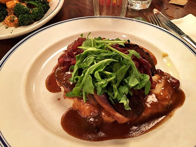 Indulge in our savory bacon-wrapped specialties, served over creamy mash with a rich glaze and fresh greens for a treat.