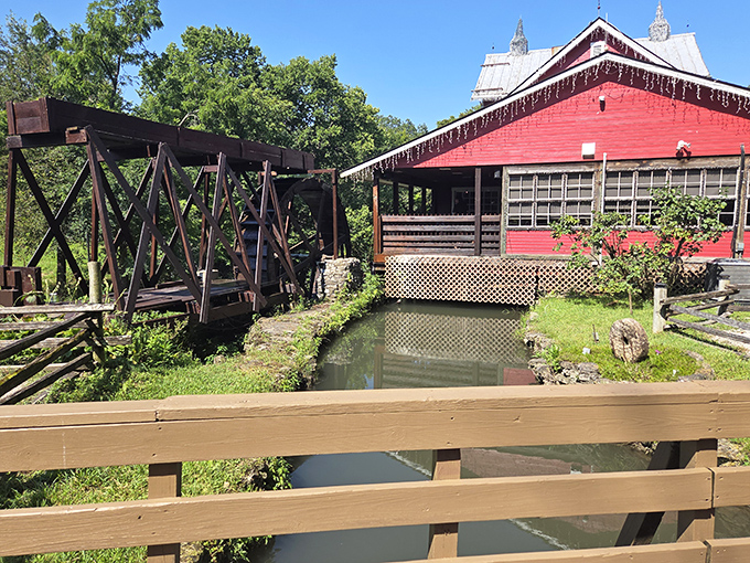 The rustic wooden bridge connects visitors to the mill's water system, a testament to functional design that's as beautiful as it is practical.