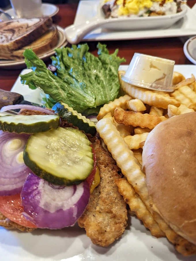 The legendary tenderloin in all its glory; crispy, golden, and hanging off the plate like it's trying to make a break for it.