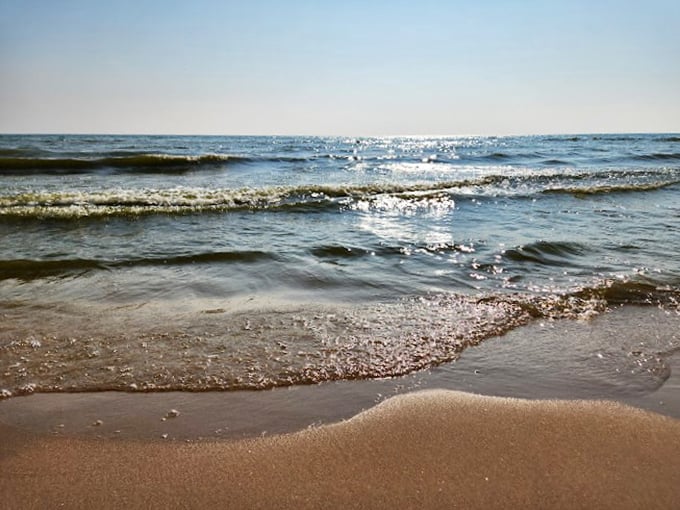 Crystal-clear shallows invite waders, while the distant horizon beckons more adventurous swimmers. Choose your own aquatic adventure!