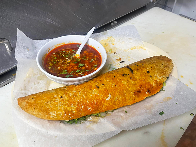 Size does matter! This mammoth 10-inch birria taco is less a meal and more a delicious, meaty frisbee of joy.