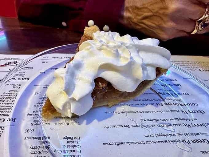 That towering slice of pecan pie topped with whipped cream is basically a hug from your grandmother in dessert form.