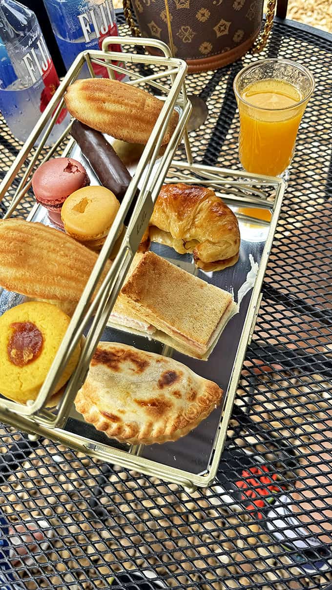 The Alvear Deluxe presents a runway of delectable pastries alongside fresh orange juice &ndash; breakfast indulgence that deserves its own boarding pass.