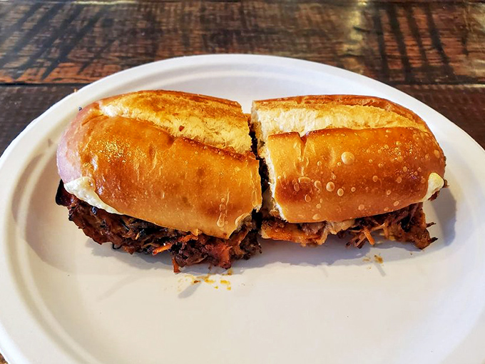 The pulled pork sandwich arrives like a savory love letter, with tender meat that surrenders at first bite and pickles that cut through the richness perfectly.