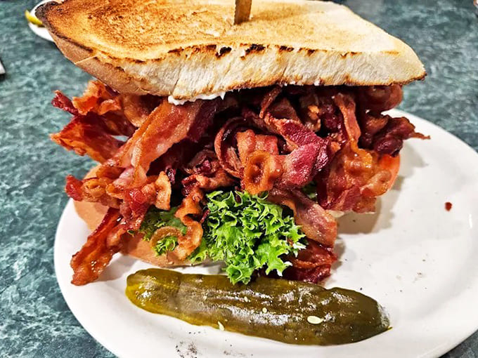 The structural integrity of this sandwich deserves an architectural award&mdash;somehow managing to contain a bacon explosion between two humble slices of toast.