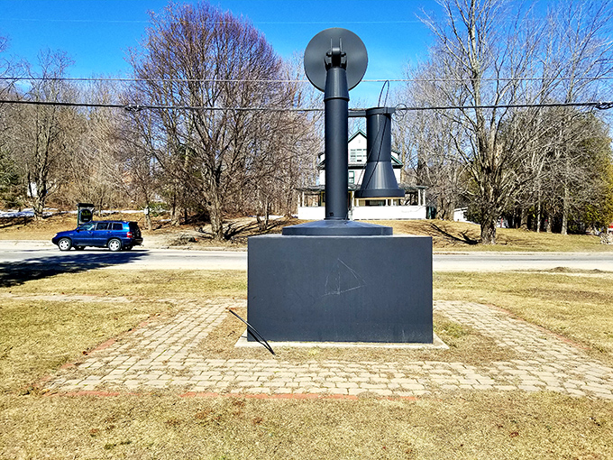 Even from behind, the telephone commands attention, its stark black silhouette creating a striking contrast against the rural Maine backdrop.