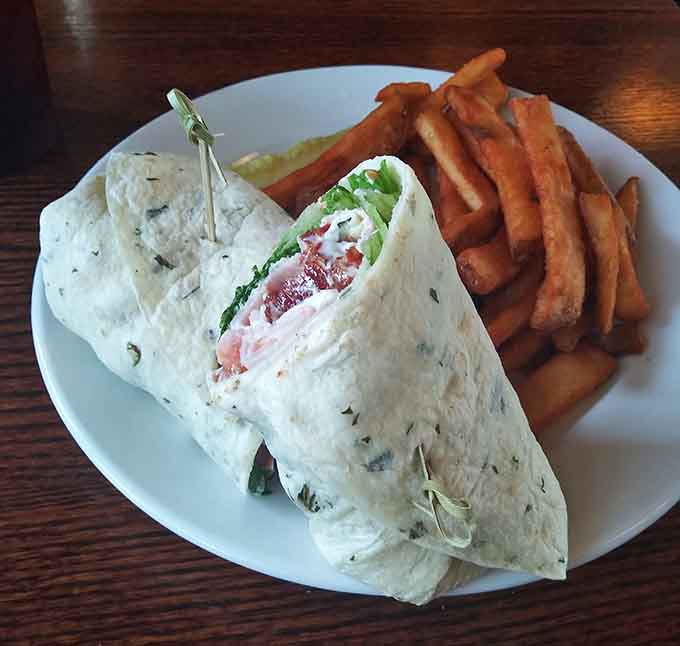This Bacon, Ham, and Turkey Wrap comes loaded with meat and fresh veggies, served alongside golden beer-battered fries that are dangerously addictive.