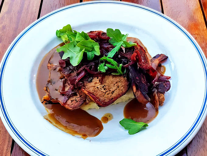 This isn't your average meatloaf! Wrapped in crispy bacon and topped with caramelized onions, it&rsquo;s pure comfort on a plate.