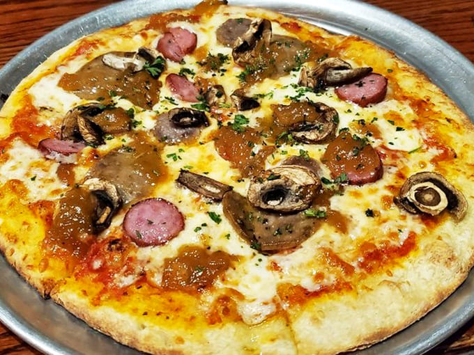 Wood-fired pizza perfection with toppings that prove sometimes you can have it all and eat it too, literally.