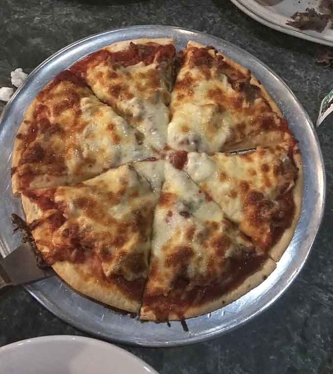 That cheese pull is real, folks, and this sausage pizza delivers exactly the kind of gooey, satisfying experience you're craving right now.