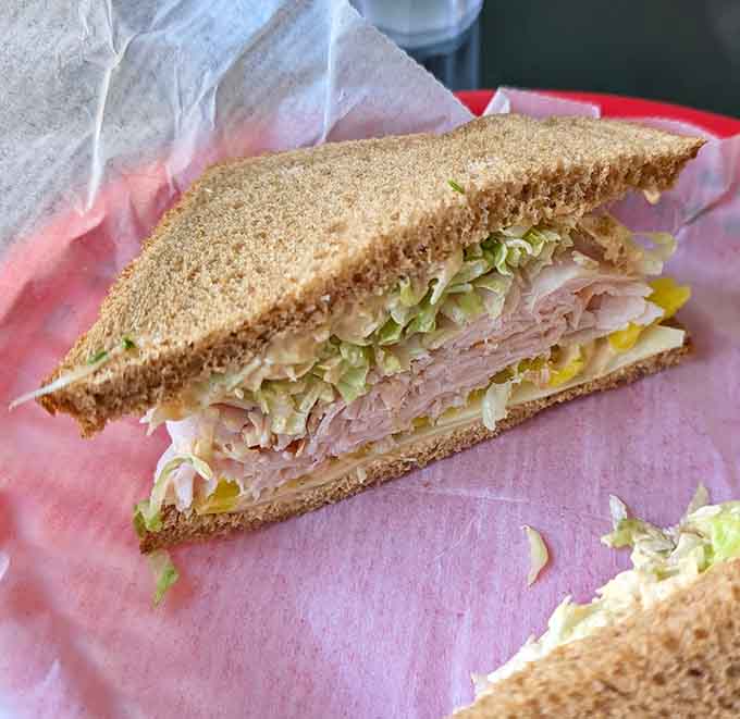 That generous stack of ham on whole grain bread with crisp lettuce proves that sometimes simple combinations create the most memorable meals.