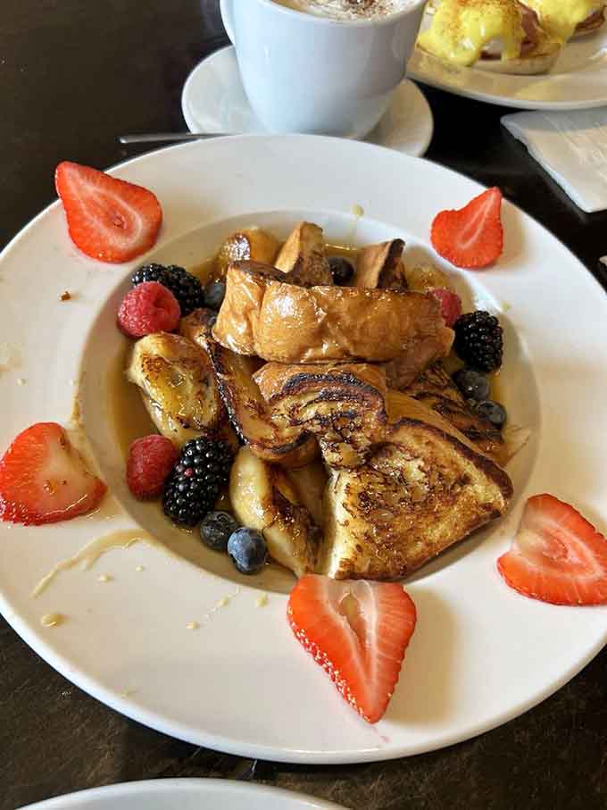 Fresh berries frame this beauty like nature's own garnish, while those caramelized bananas add sweetness that'll make your morning infinitely better.