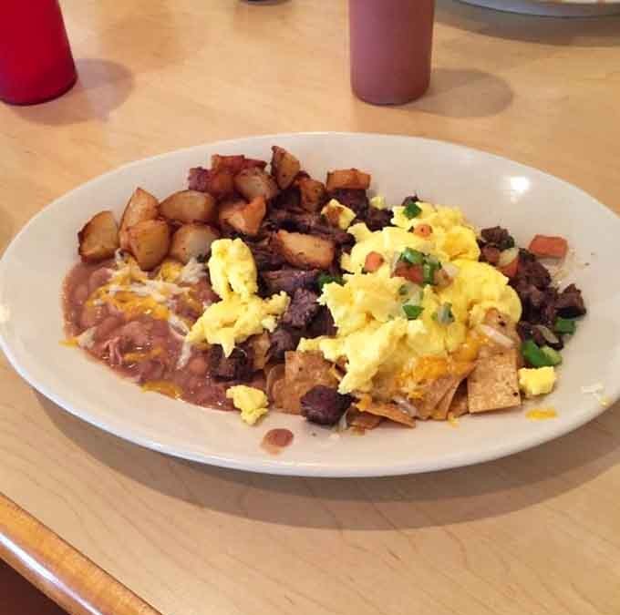 Green chilaquiles with carne asada turns breakfast into a full-blown event, complete with beans, potatoes, and zero regrets.
