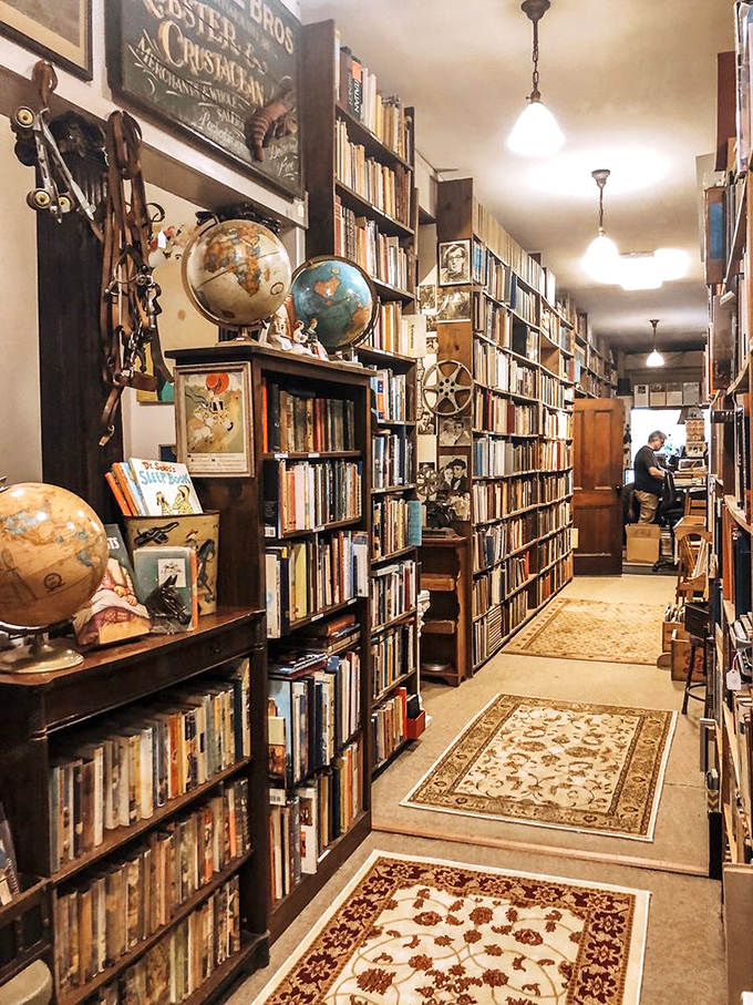 Antique globes and nautical treasures share space with countless volumes, creating a cabinet of curiosities for the intellectually adventurous.