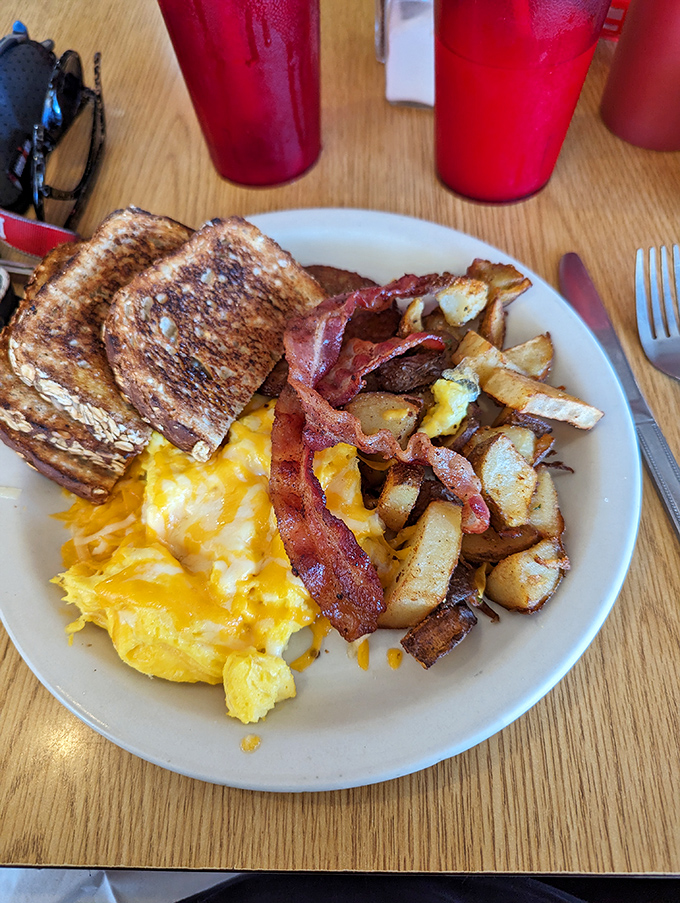 Morning glory on a plate &ndash; golden toast, perfectly scrambled eggs, crispy bacon, and potatoes that could make a hash brown weep with envy.